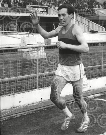 32497356-Olympic Athlete Jim Alder James Alder waves as he finished his ...