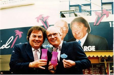 38612368-Eddie Large and Syd Little with pink cocktail glasses in front ...