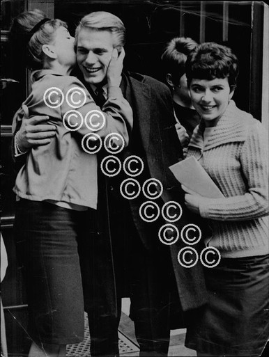 37994308-Singer Adam Faith, 23, gets a kiss from an excited typist as ...