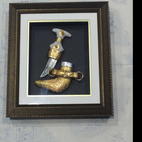 Golden omani dagger in brown wall mount frame , souvenir