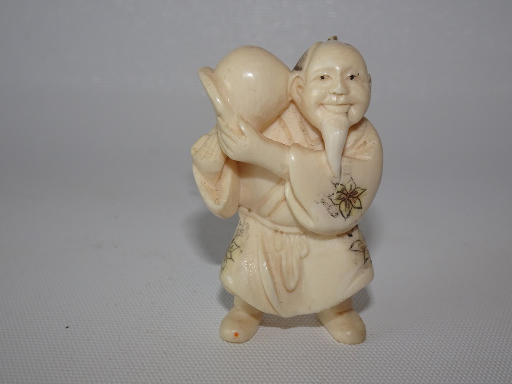 Japanese Ivory Netsuke Man Holding an Item | Marple Antiques