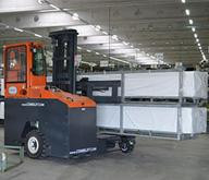 Combilift Combilift - Moving Products Stored In Stacking Racks In A Factory