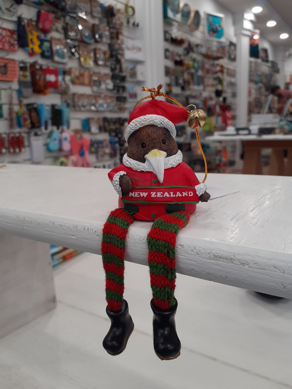 Santa hanging Kiwi ornament with New Zealand sign and dangling legs ...