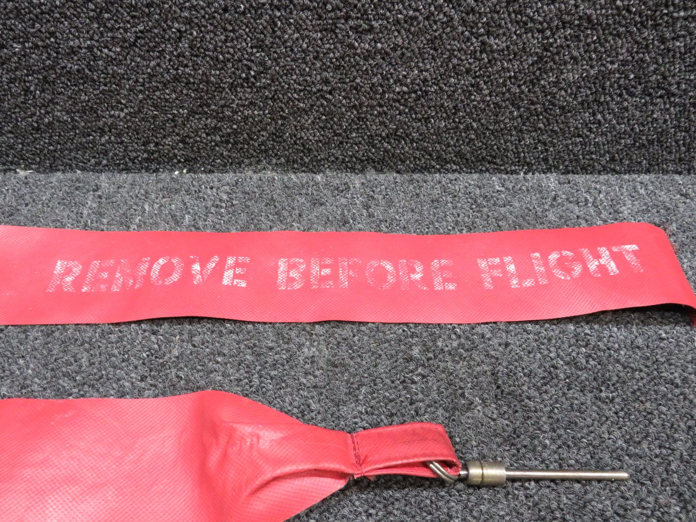 Red Remove Before Flight Banner With Faded Lettering