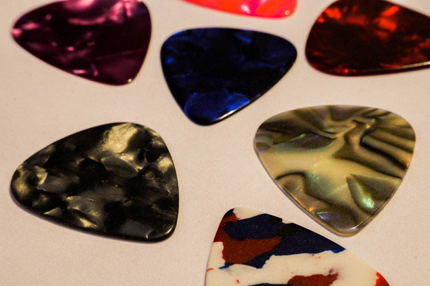 Comparing Guitar Pick Materials - Strings and Beyond