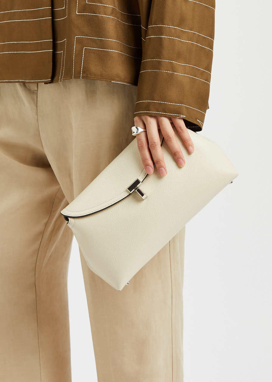 TOTEME T-Lock leather clutch | Harvey Nichols
