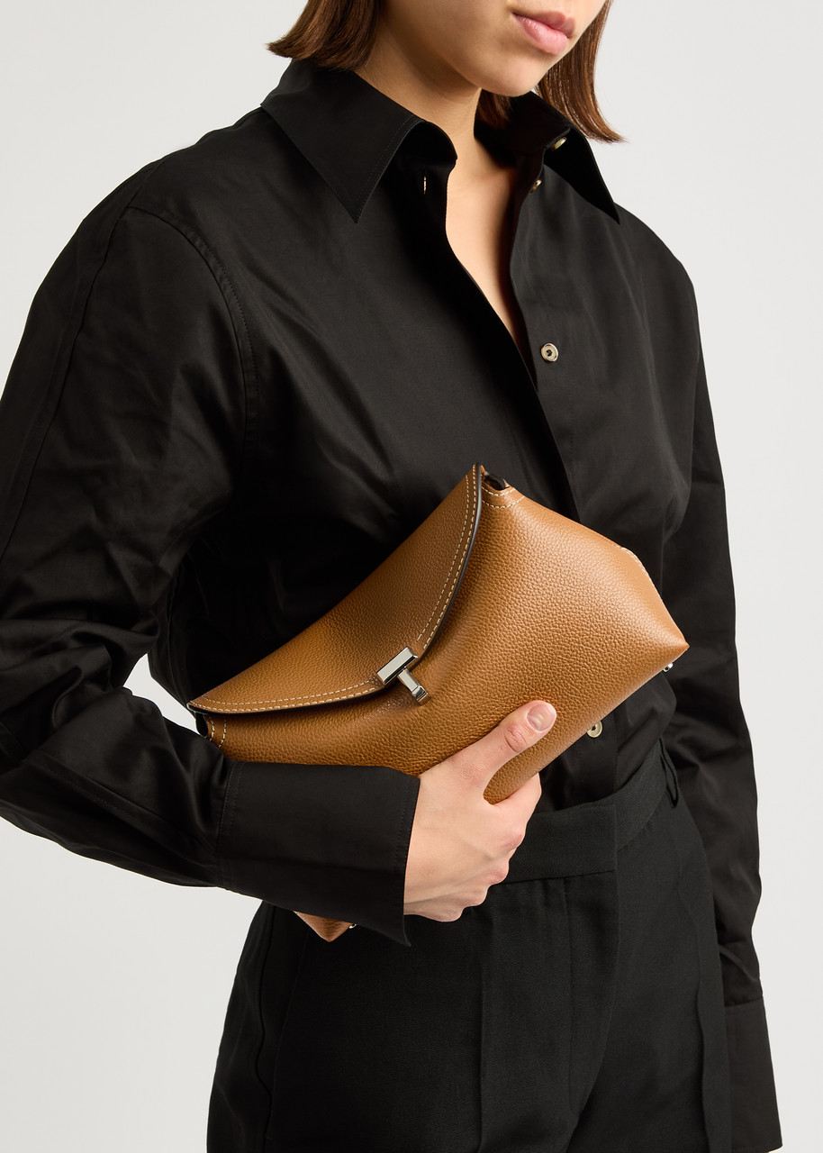 TOTEME T-Lock leather clutch | Harvey Nichols