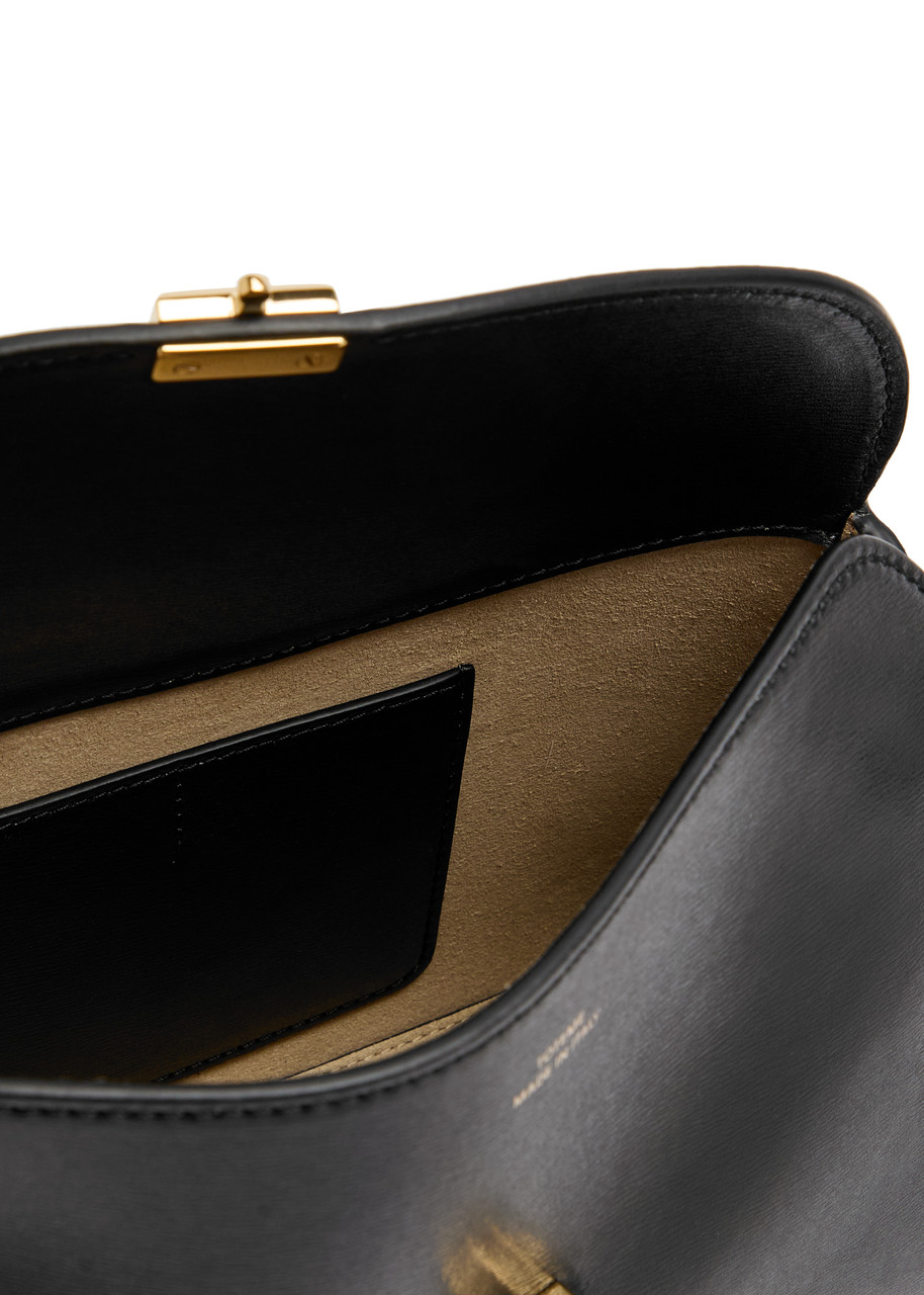 TOTEME T-lock leather clutch | Harvey Nichols