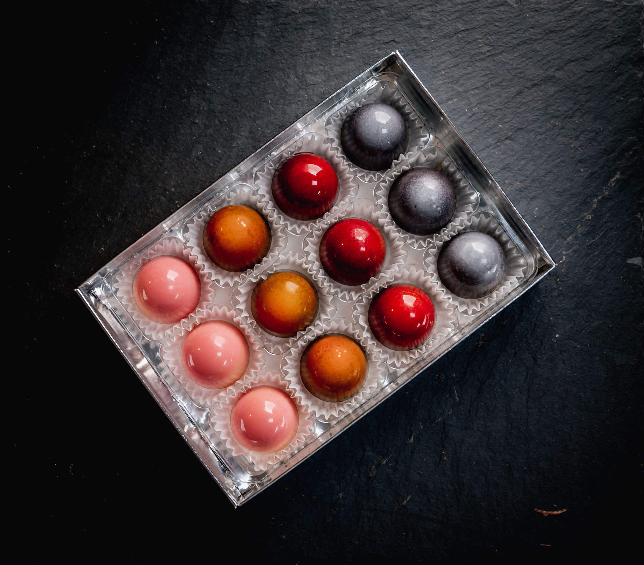 Brecon Gin Bonbons. 3 each White chocolate Rose Gin. Milk Chocolate ...