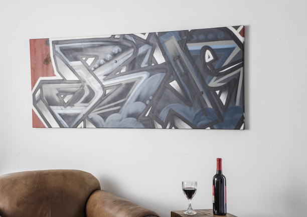 Spray painted monochromatic gray graffiti art on steel canvas
