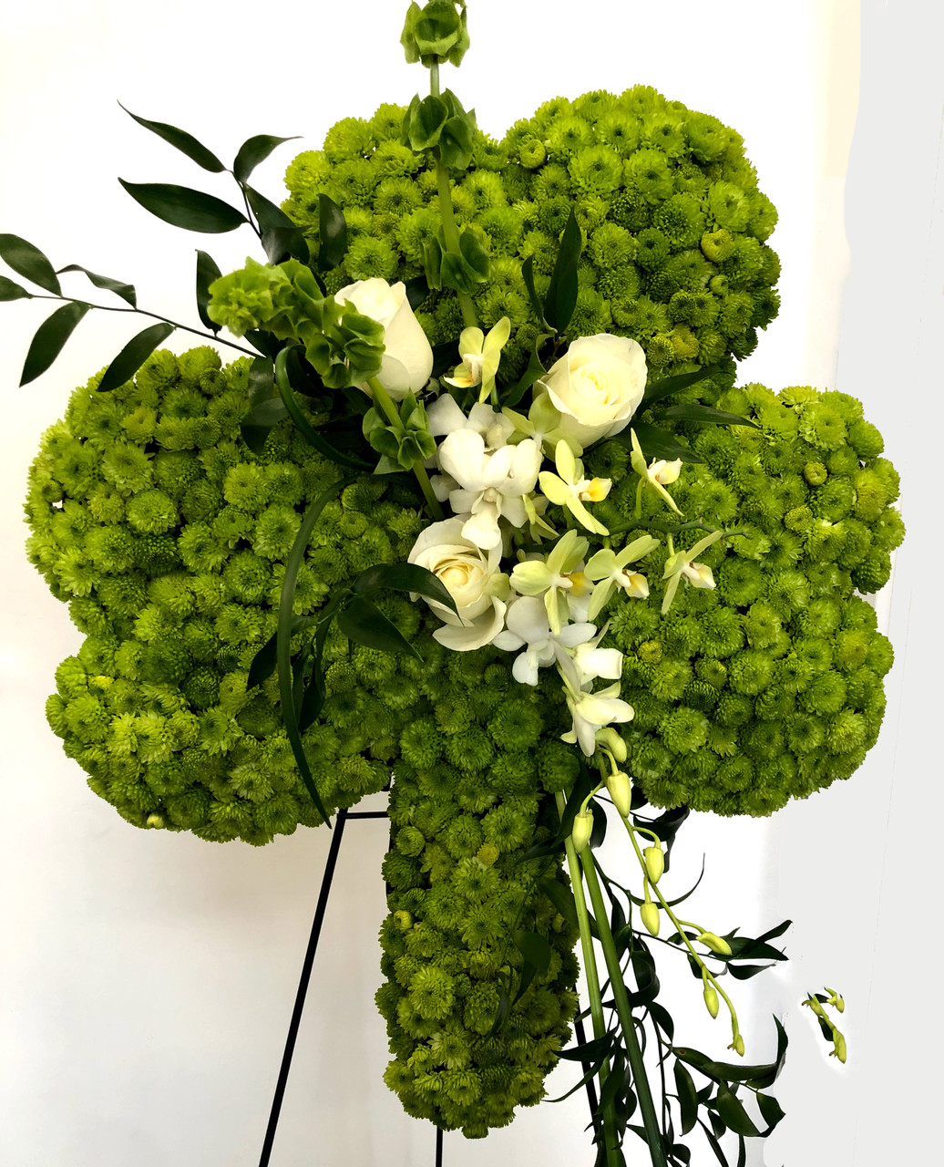 floral tributes crossword clue