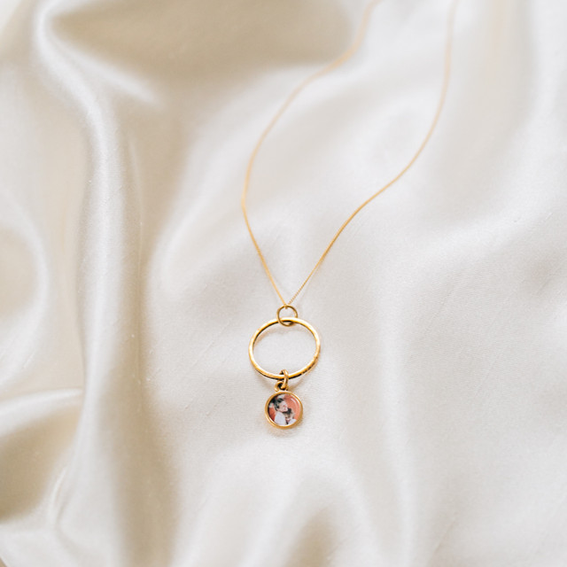 Petite modern gold locket with large ring pendant connecting it to the ...