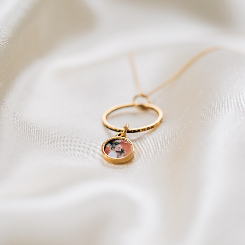 Petite modern gold locket with large ring pendant connecting it to the ...