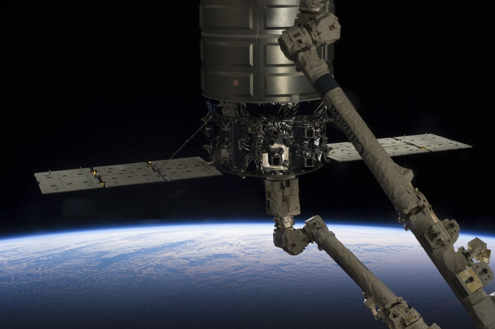 Canadarm2 robotic arm prepares to release the Cygnus spacecraft Poster ...