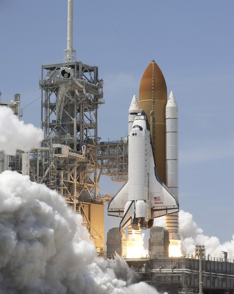 Atlantis' twin solid rocket boosters ignite to propel the spacecraft ...