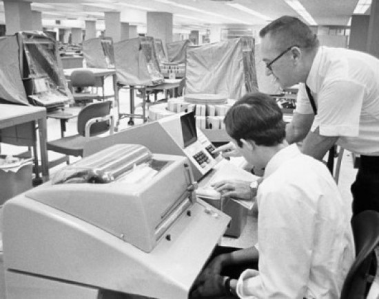 Office worker demonstrates the computer interrogation device for ...