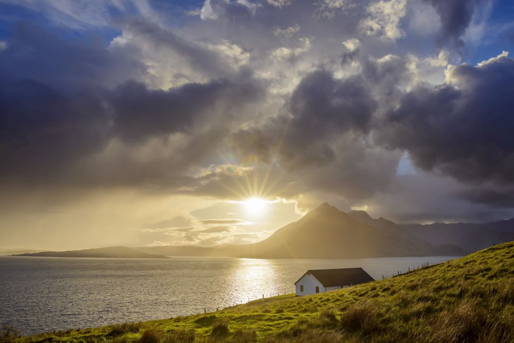 Rooftop of a house along the Scottish coast with sun shining through ...