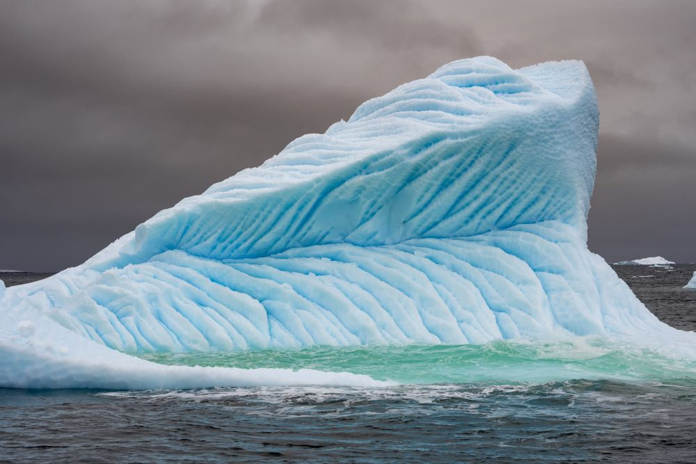 Iceberg floating against stormy sky; Antarctica Poster Print by Michael ...