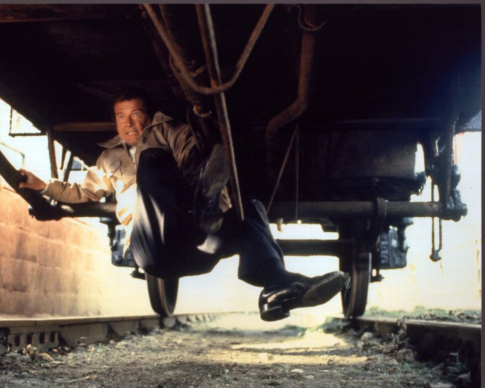 Roger Moore Under Train Car In Octopussy Photo Print (8 x 10) - Posterazzi
