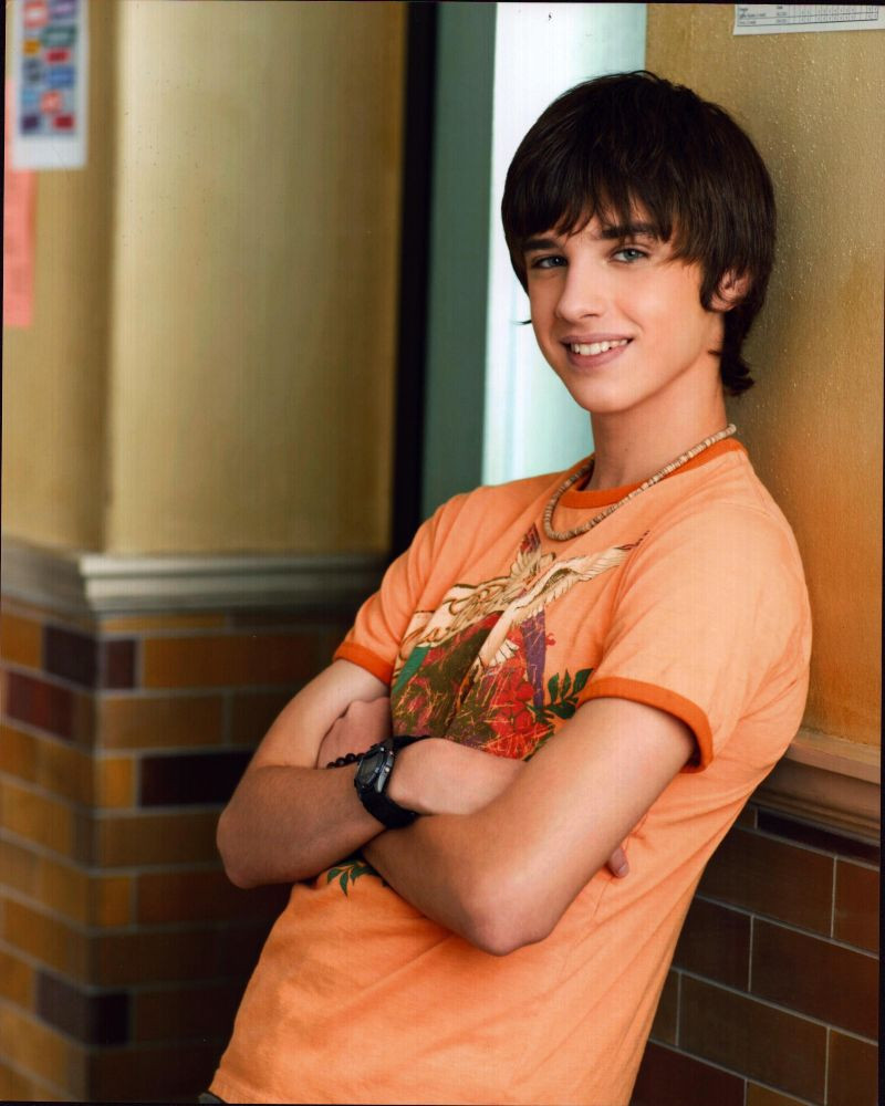 David Lambert In Orange Shirt Leaning On Wall Photo Print - Item # MVM58545 - Posterazzi