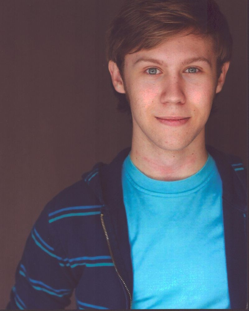 Aaron Christian Howles Headshot N Blue Shirt And Striped Sweatshirt ...