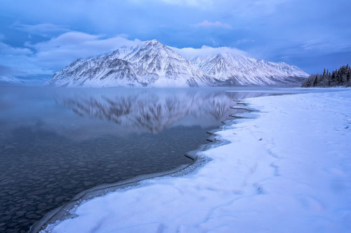 Beautiful winter landscape in the Yukon. The frozen shores of Kathleen ...