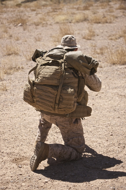 A U.S. Marine pulls security while his team boards a UH-60 Black Hawk ...