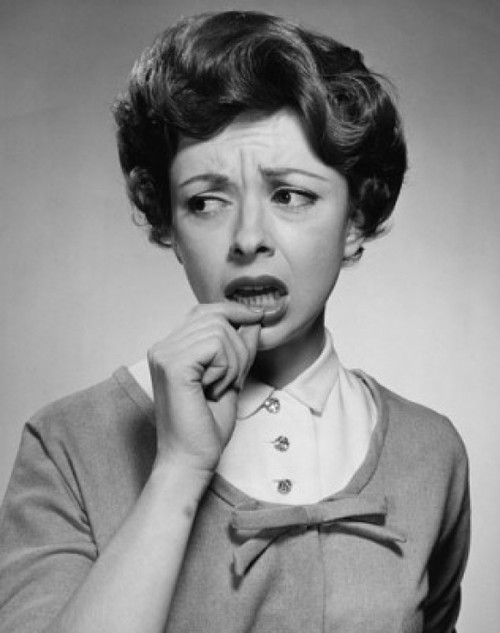 Close-up of a young woman pinching her bottom lip Poster Print - Item ...