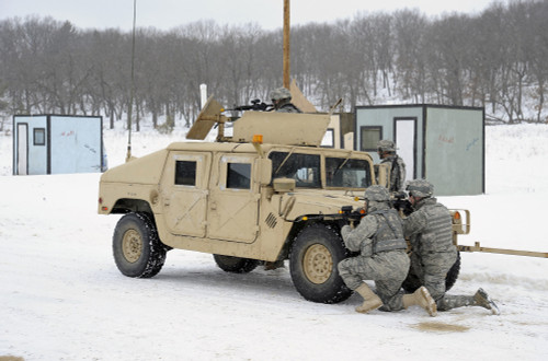 U.S. soldiers take cover behind a humvee during Combat Support Training ...