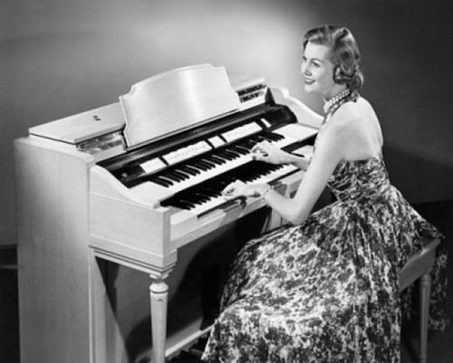 Side profile of a young woman playing an organ Poster Print - Item ...
