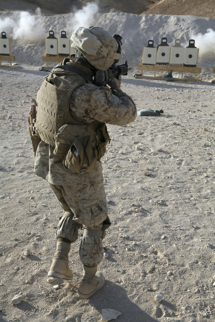 A soldier engages his target on a shooting range at Al Asad, Iraq ...