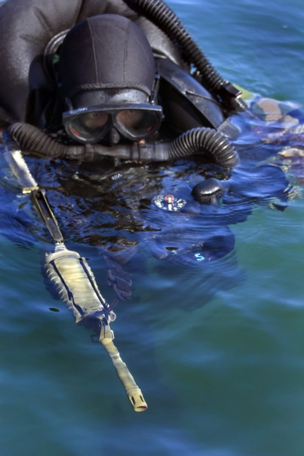 A Navy SEAL combat swimmer diving a closed circuit oxygen rebreather ...