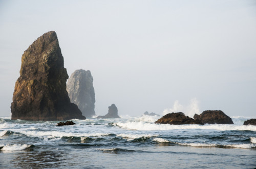 Waves break around the stone needles; Cannon Beach, Oregon, United ...