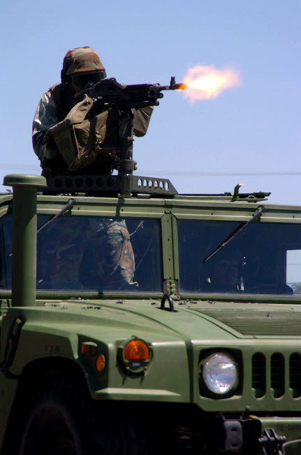 Soldier shoots a M-240B machine gun atop a humvee Poster Print by ...