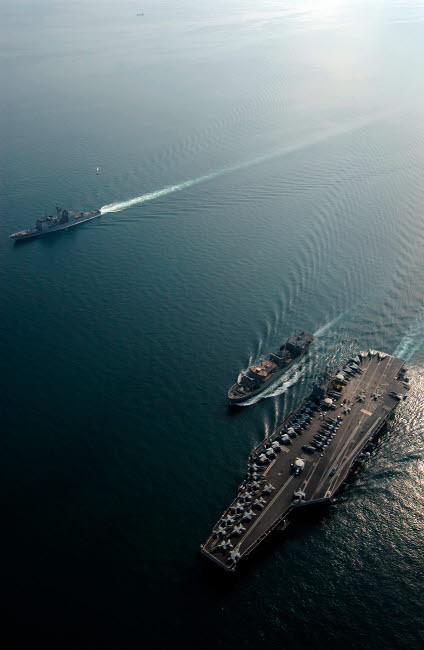 USNS Saturn conducts a vertical replenishment at sea with USS Harry S ...