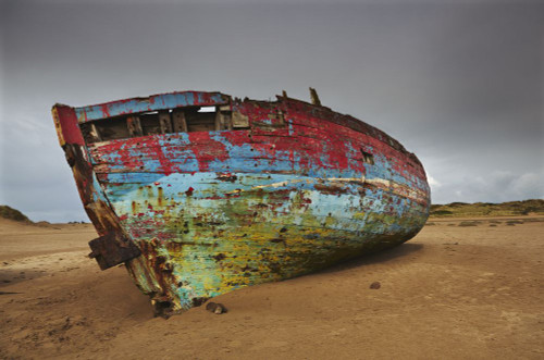 Colourful weathered shipwreck lying in sand dunes at Crow Point, at the ...