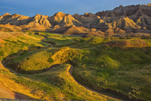 The area called yellow mounds lit by the sunset in badlands national ...