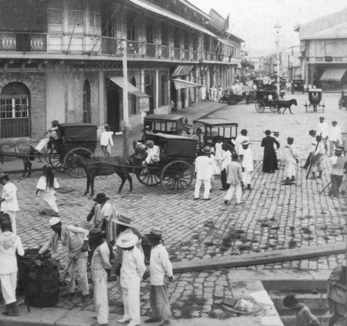 Historic image in black and white of people on the cobblestone street ...