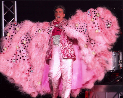 Liberace In Pink Suit With Feather Cape Photo Print (8 x 10) - Posterazzi