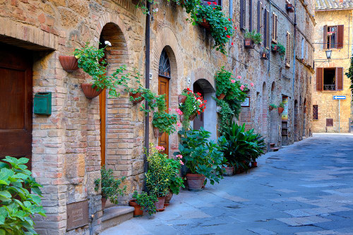 Italy-Tuscany-Pienza Flower pots and potted plants decorate a narrow ...